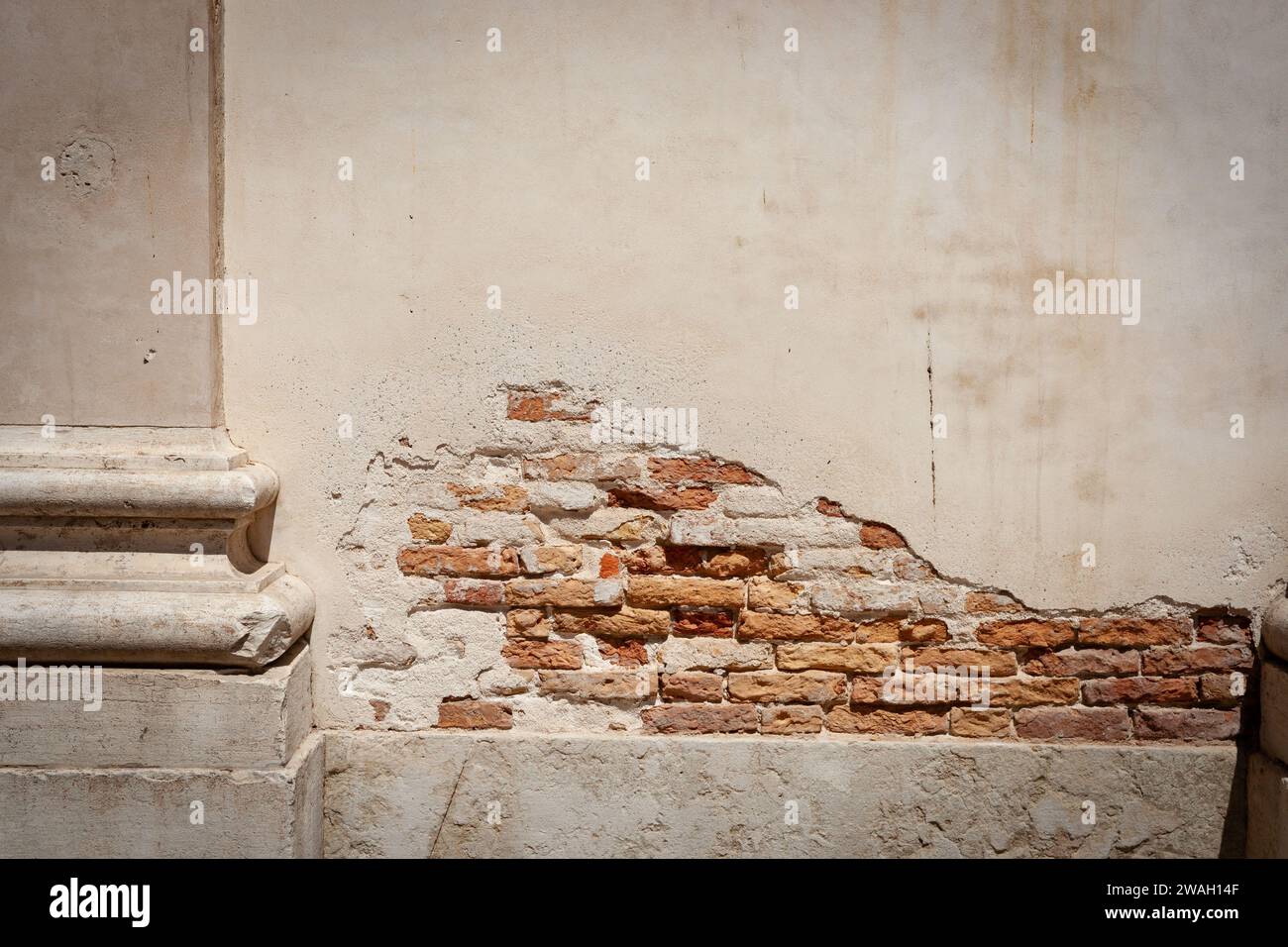 Old wall with plaster render falling off exposing brick in need of ...