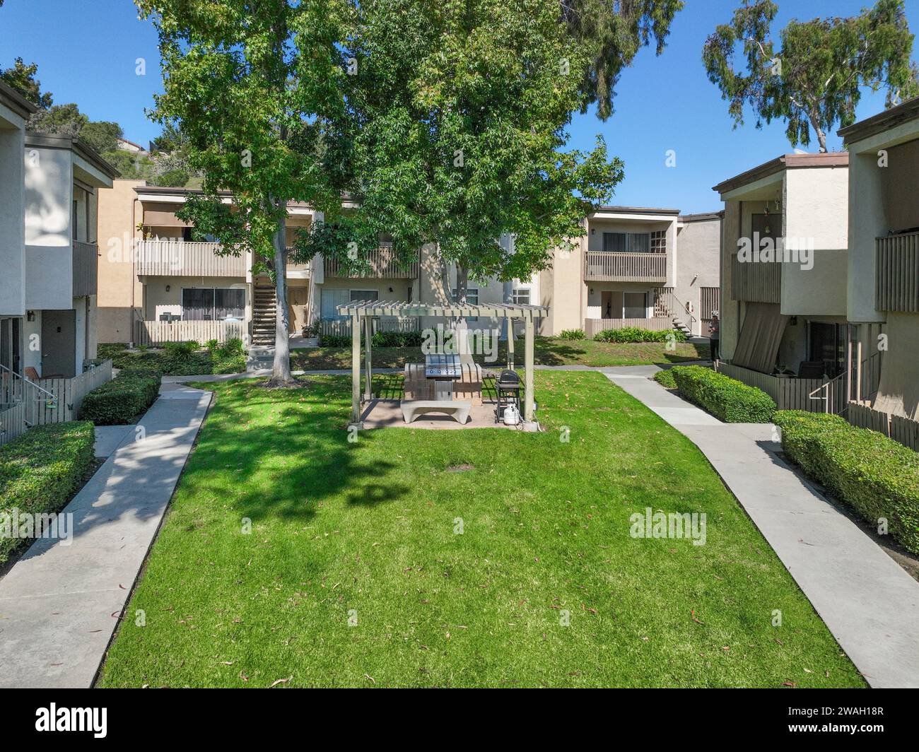 Garden and lawn along the walk path through the typical apartment ...
