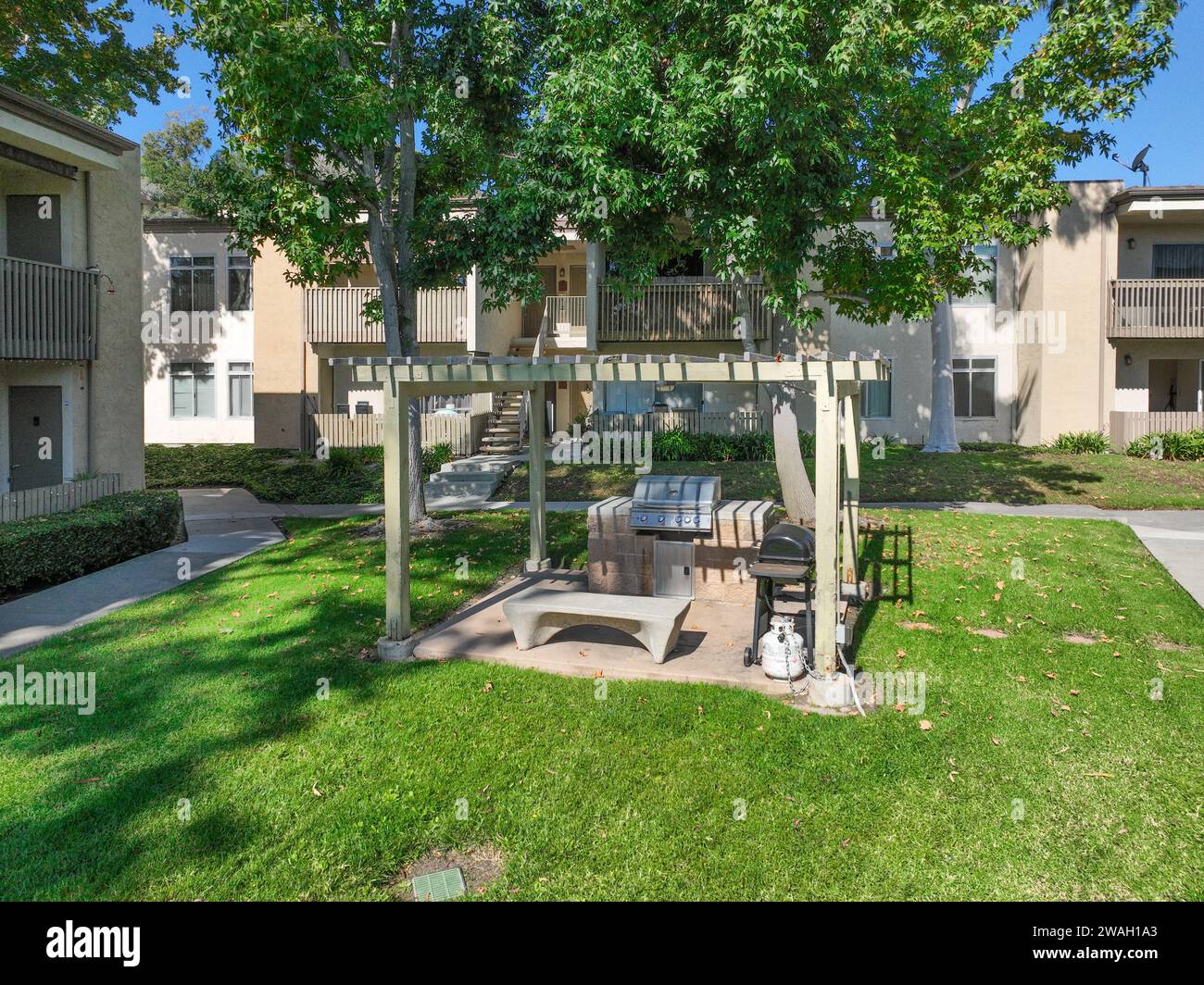 Garden and lawn along the walk path through the typical apartment ...