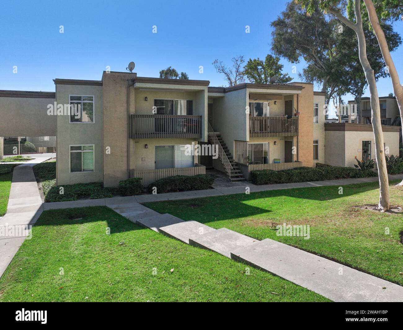 Garden and lawn along the walk path through the typical apartment ...