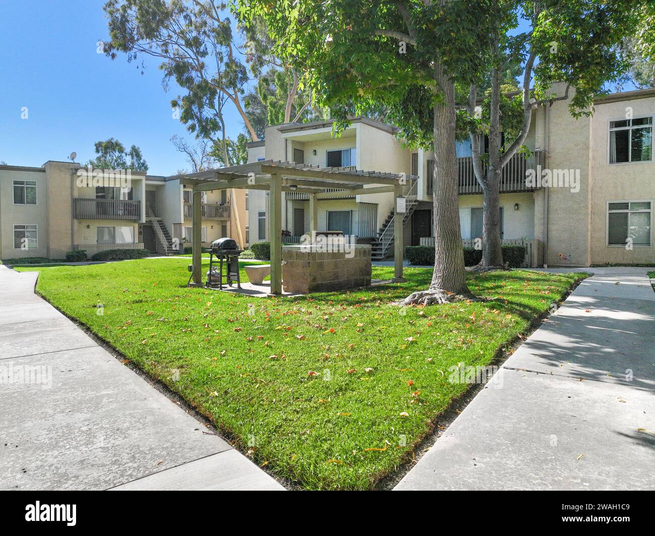 Garden and lawn along the walk path through the typical apartment ...