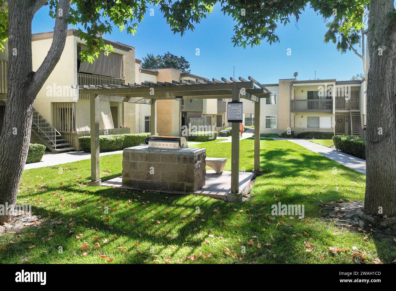 Garden and lawn along the walk path through the typical apartment ...