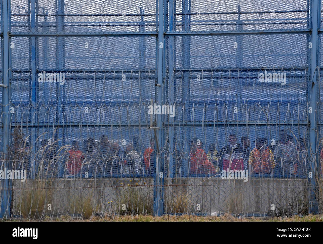 FILE - Inmates are held at a prison yard after a deadly riot in ...