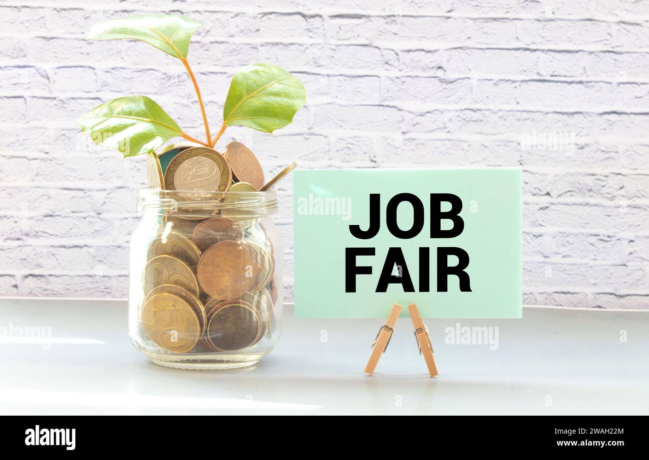 JOB FAIR text on notebook on graph background with pen and magnifier ...