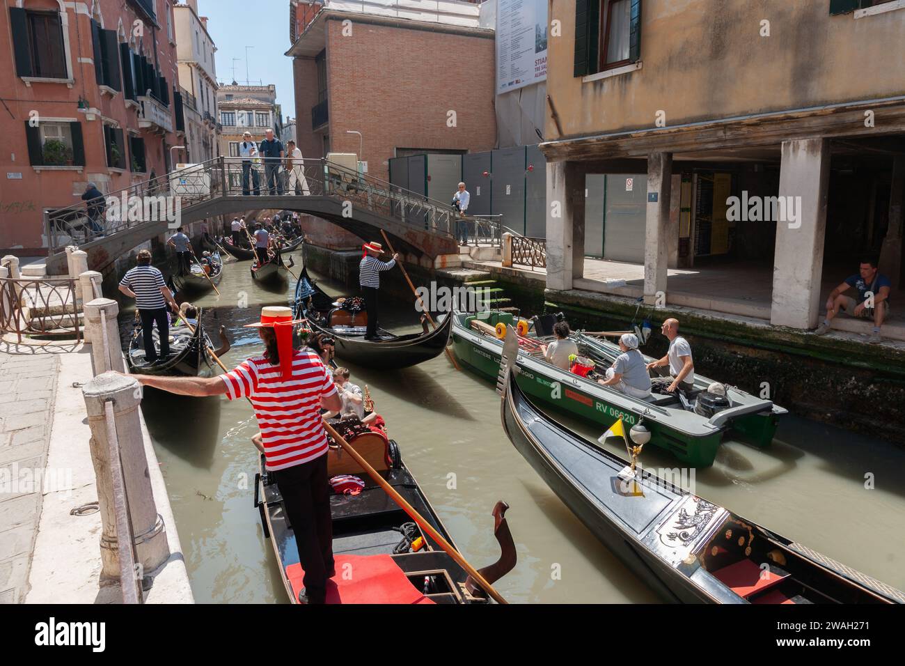 Venice Italy - May 10 2011; Gondola packed with tourists on narrow ...