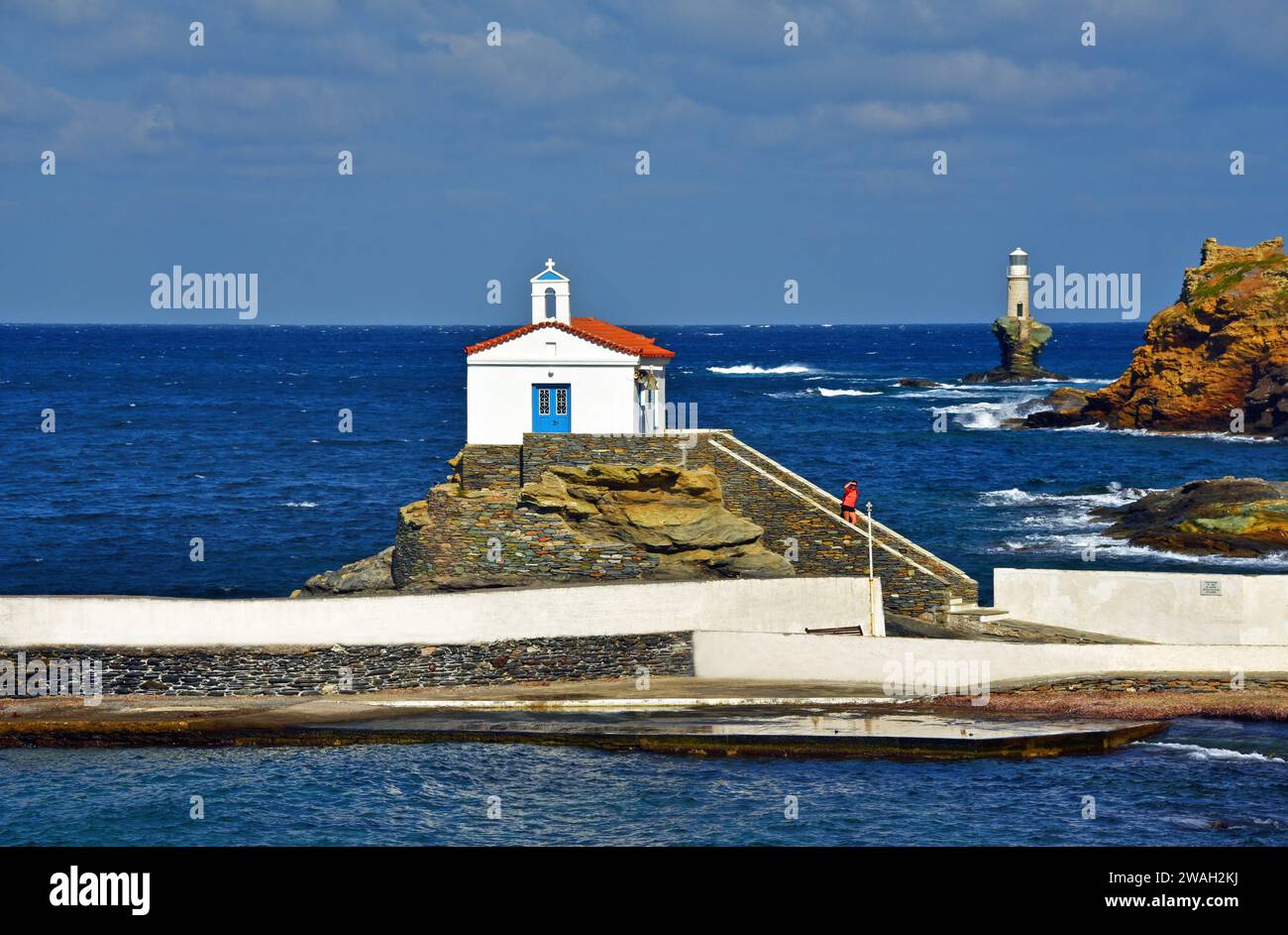 church Panagia Thalassini and Tourlitis lighthouse on the rocky coast ...