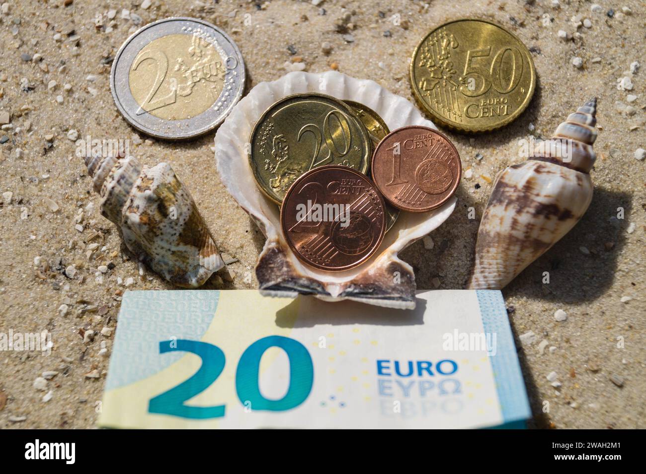 money and shells in the sand, symbol image travel expenses Stock Photo ...