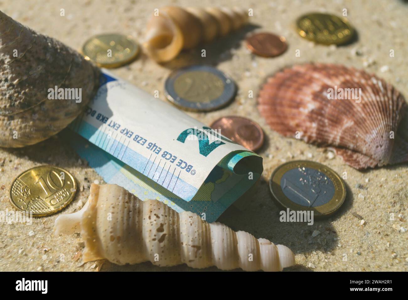 money and shells in the sand, symbol image travel expenses Stock Photo ...
