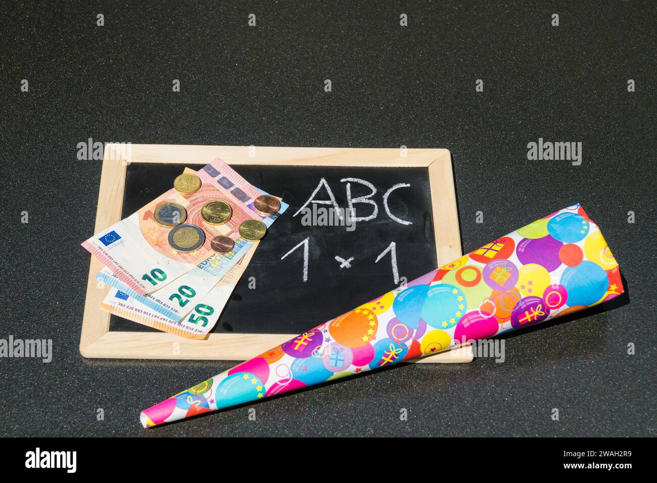 school cone, slate and money, symbolic image for school fees Stock ...