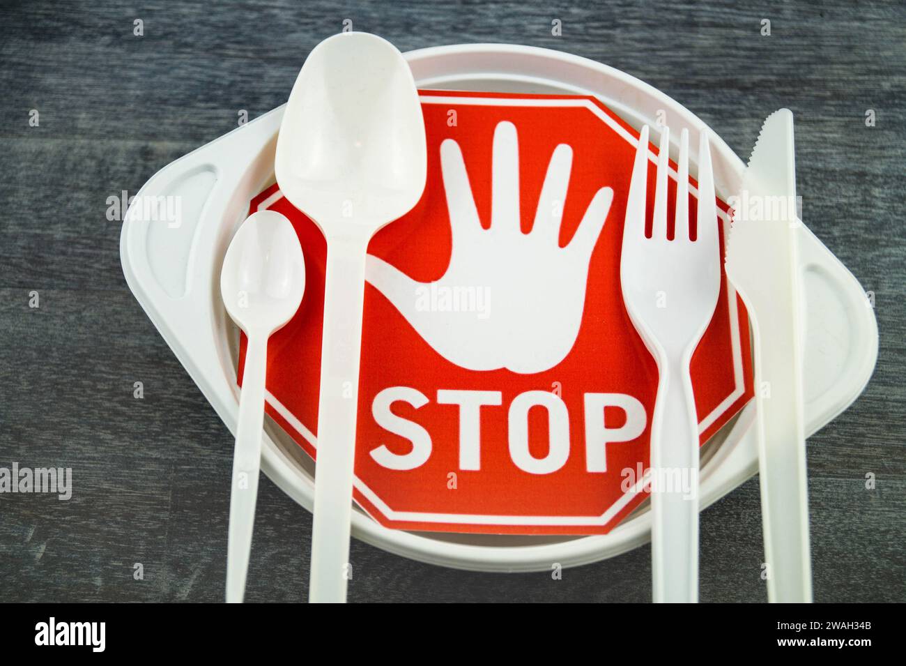single-use tableware, plastic cutlery and stop sign, symbolic picture ...