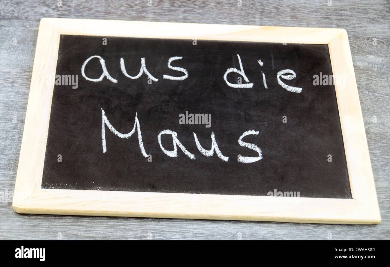 black board with the inscription 'Aus die Maus' at the end of a ...