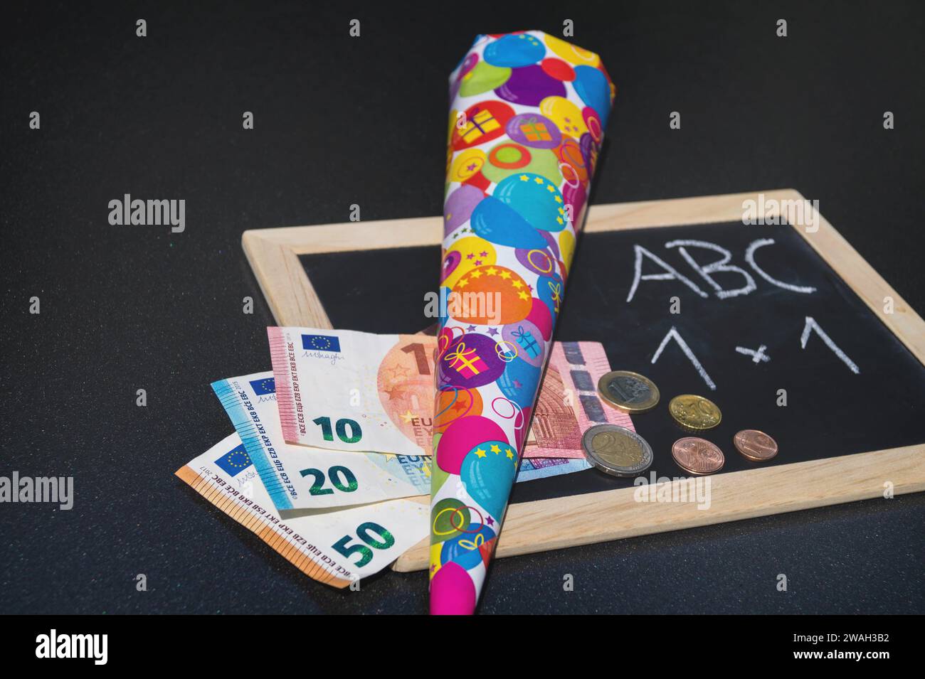school cone, slate and money, symbolic image for school fees Stock ...
