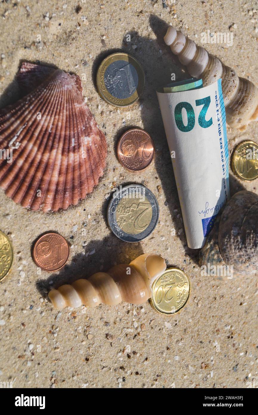 money and shells in the sand, symbol image travel expenses Stock Photo ...