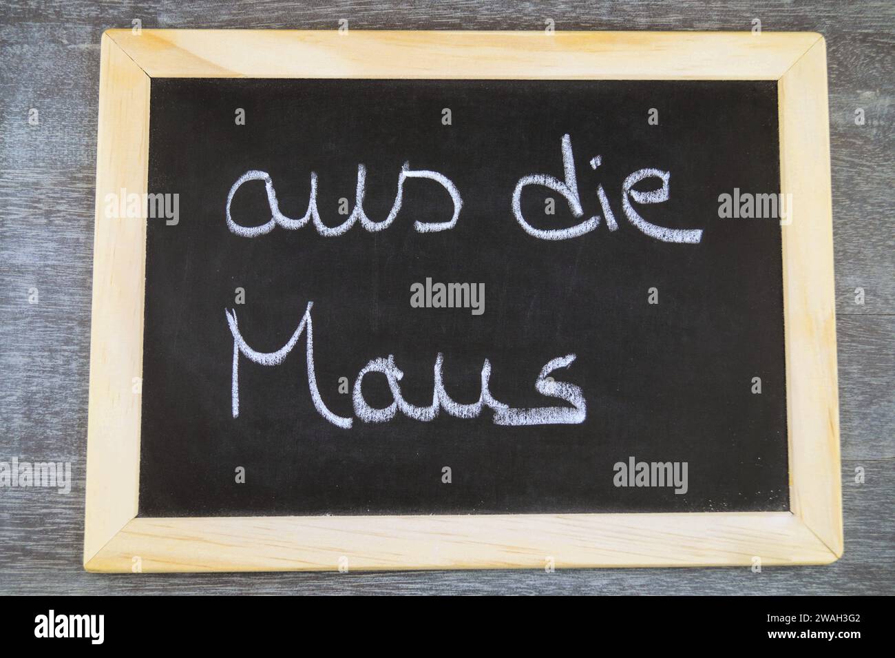 black board with the inscription 'Aus die Maus' at the end of a ...