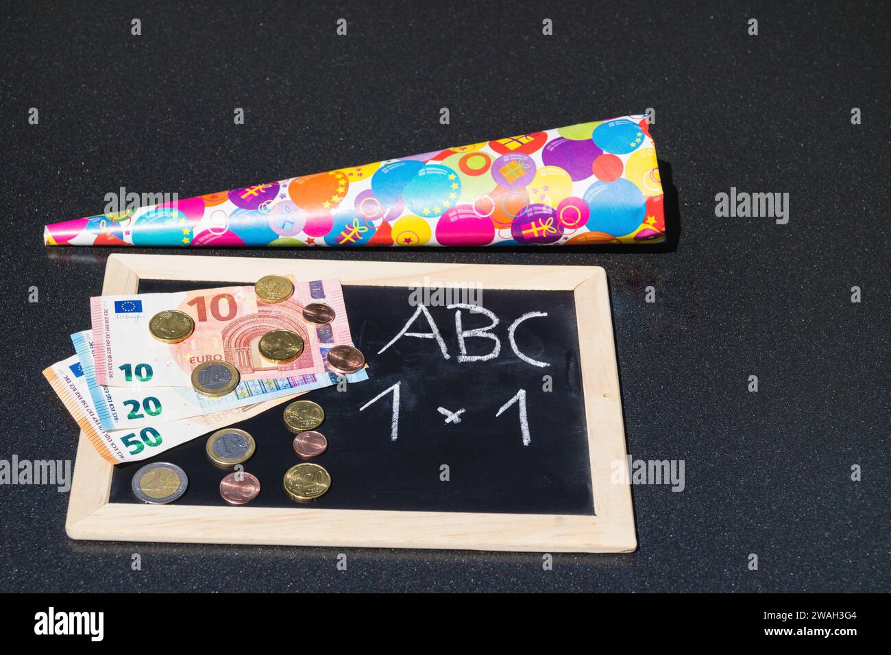 school cone, slate and money, symbolic image for school fees Stock ...