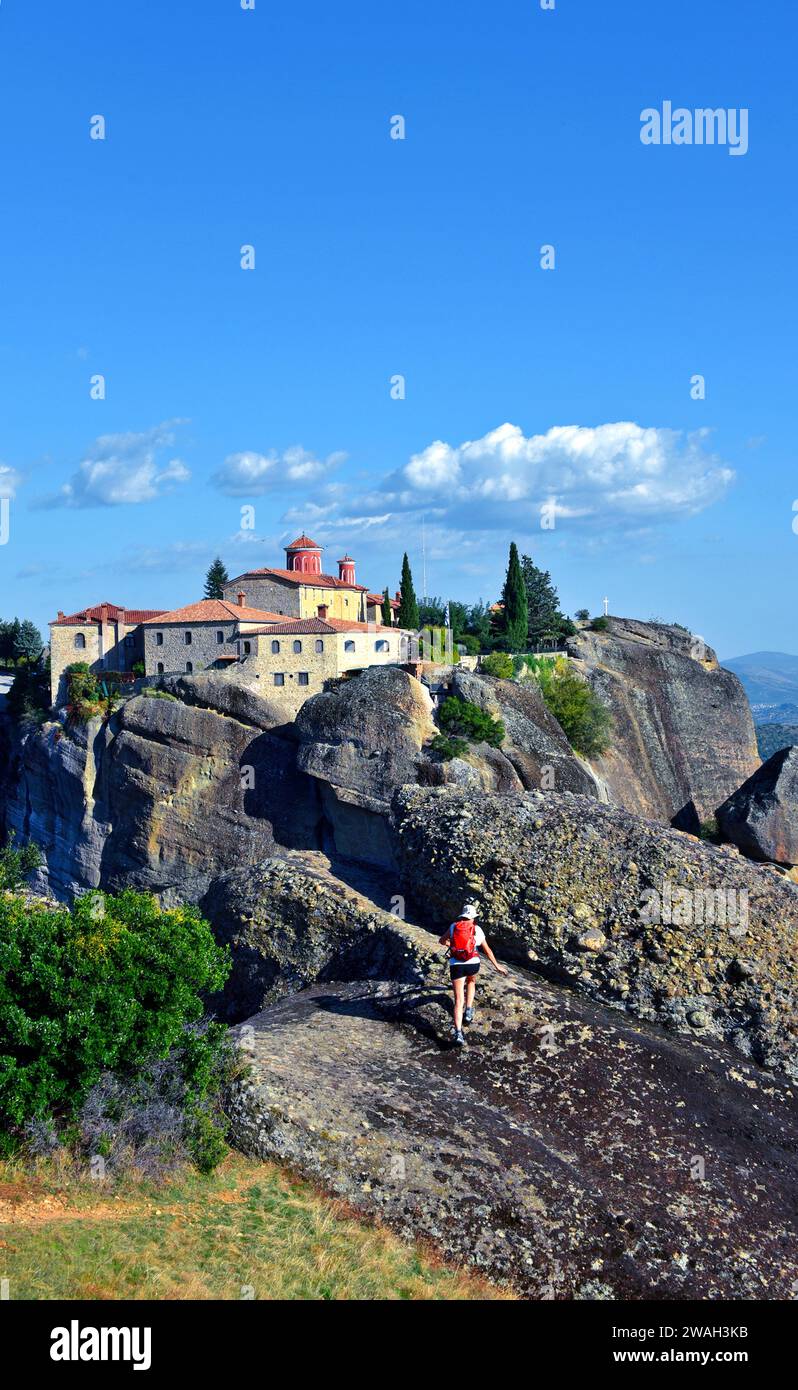 Hiker on the hiking trail in front of the monastery of Saint Stefanos ...