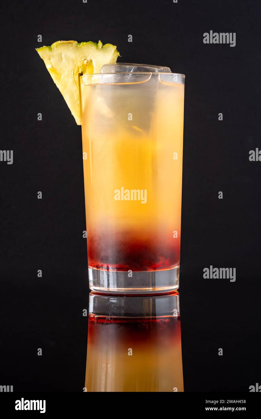 Reggae Rum Punch Cocktail garnished with pineapple wedge Stock Photo ...