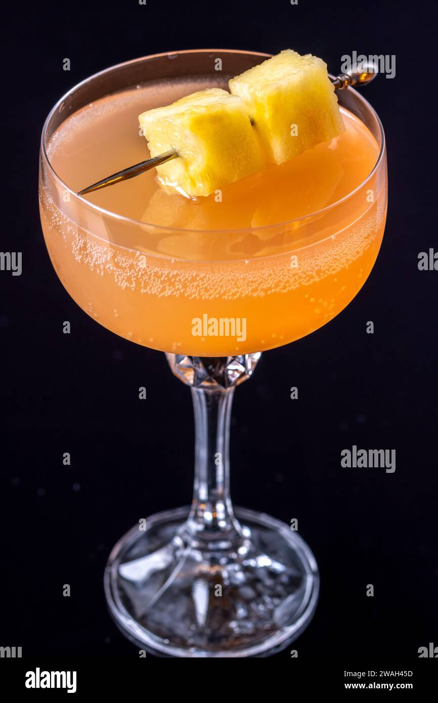 Only fans Martini cocktail garnished with pineapple cubes Stock Photo - Alamy