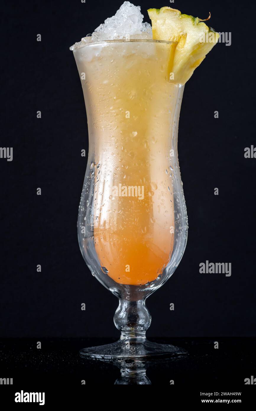 Glass of Tilt cocktail on the black background Stock Photo - Alamy