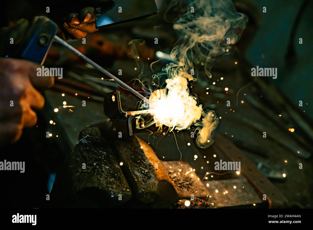 Welding metal with electrodes, sparks and smoke Stock Photo - Alamy