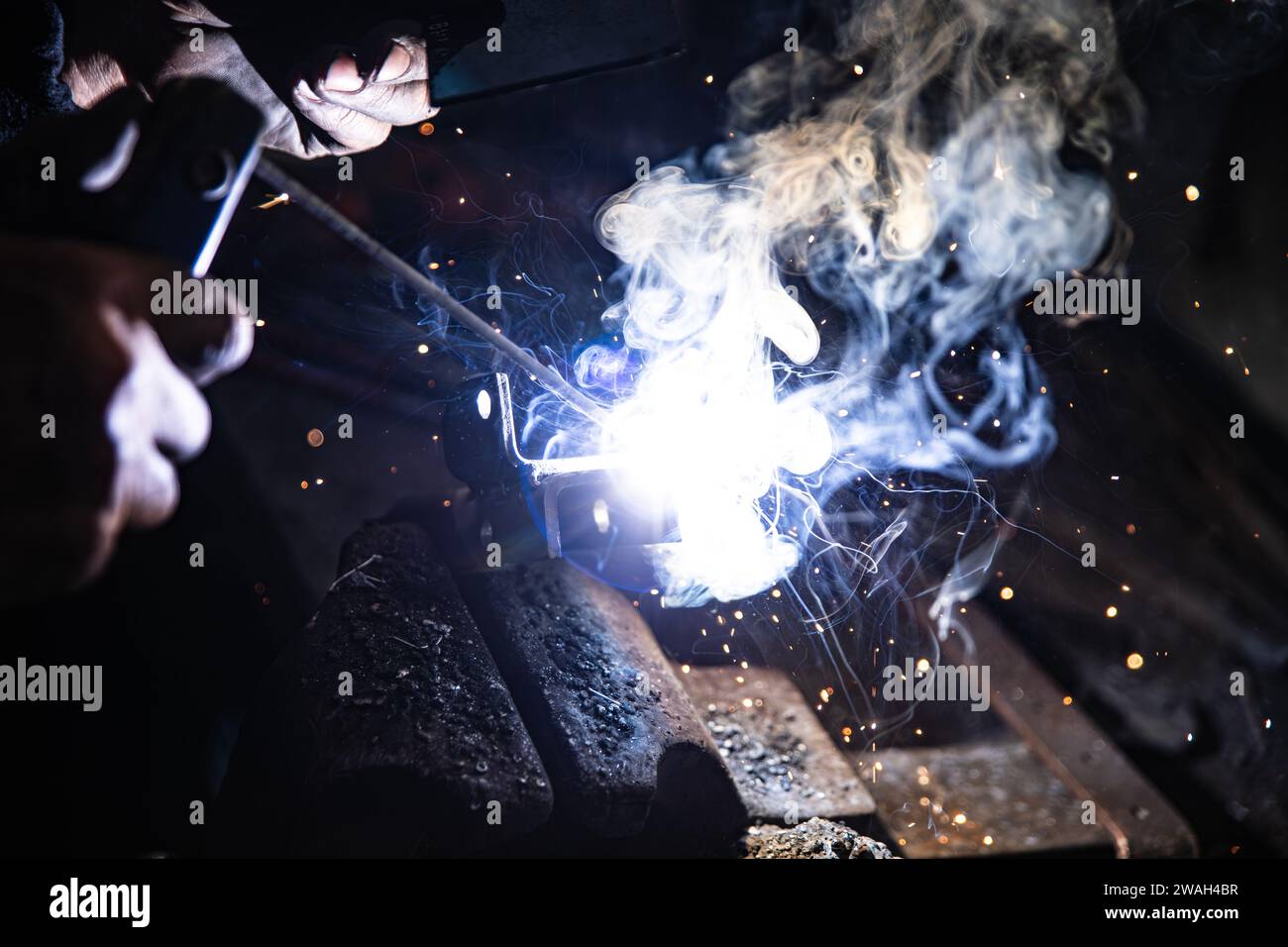 Welding metal with electrodes, sparks and smoke Stock Photo - Alamy