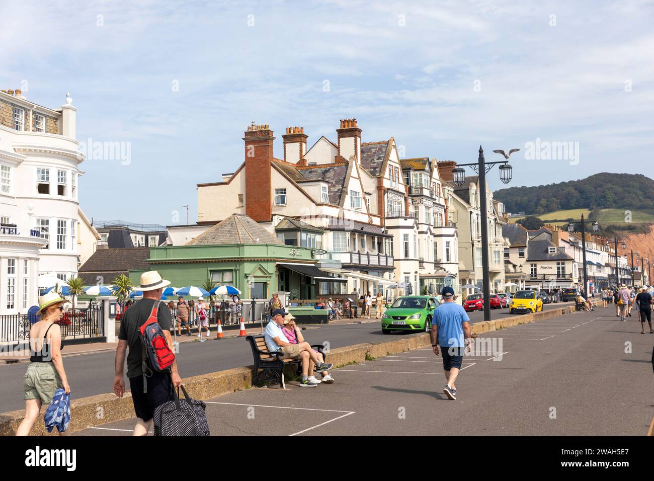 Sidmouth Devon England people walking along the esplanade on a hot ...