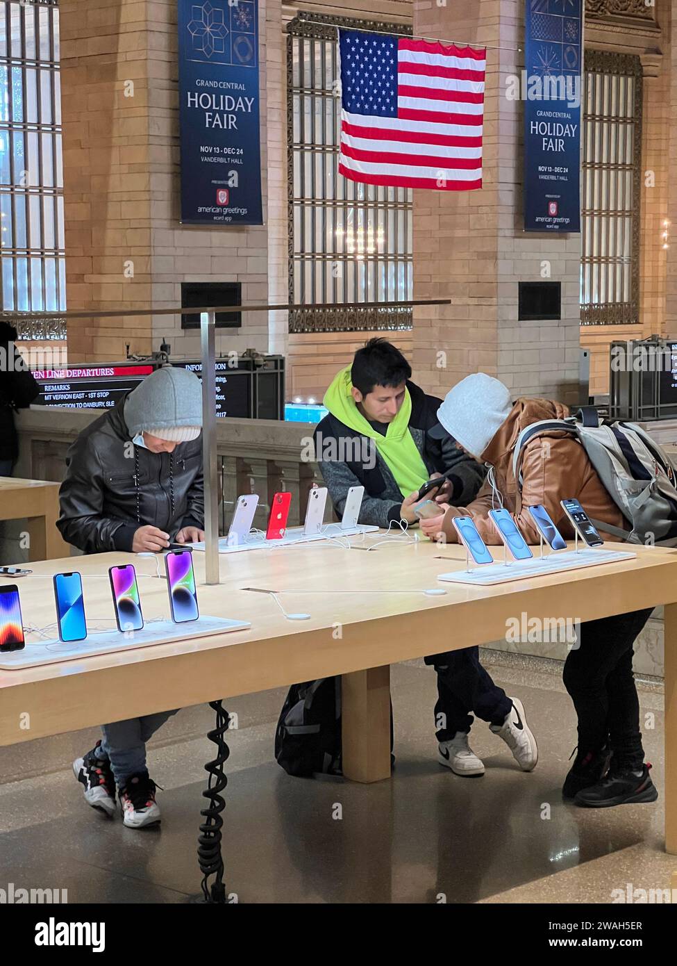 Young men checking out the newest Apple iphones at the Apple Store at ...