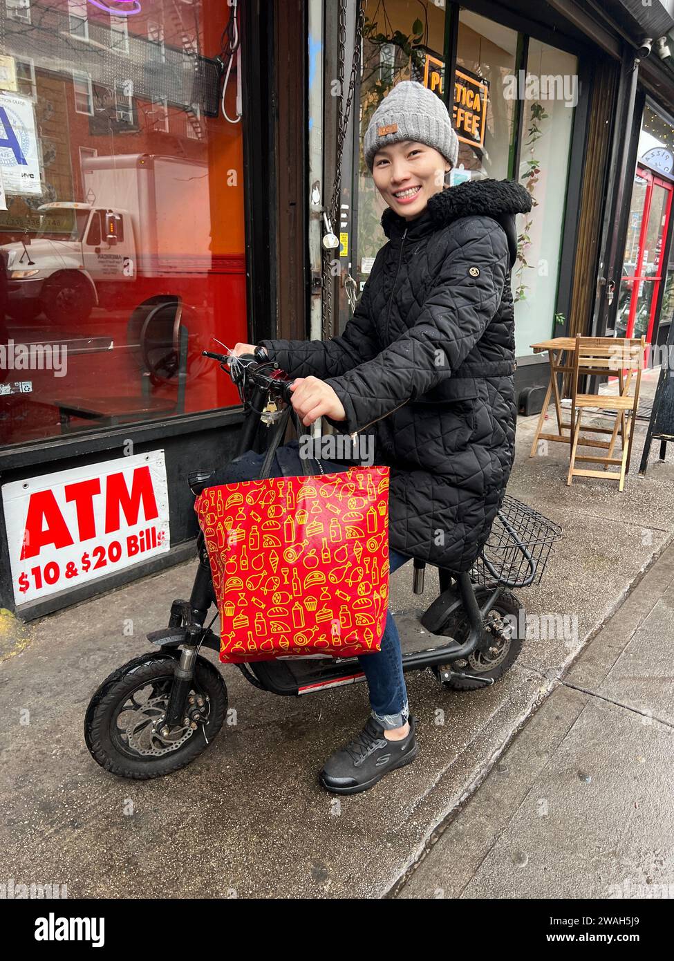 Portrait of a Chinese restaurant owner on her electric Bike Stock Photo ...