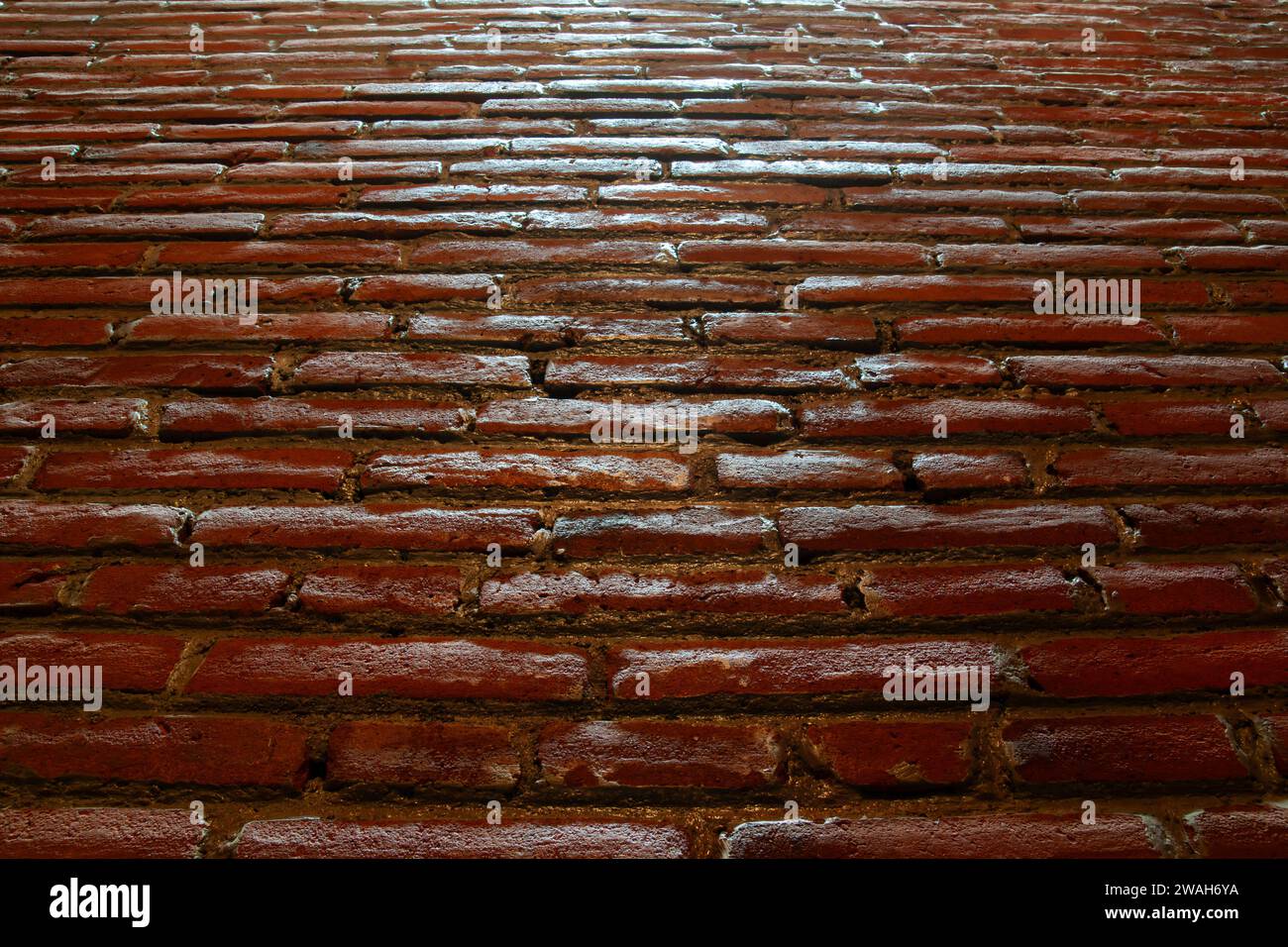 The red brick wall seen from below shows light from above Stock Photo ...