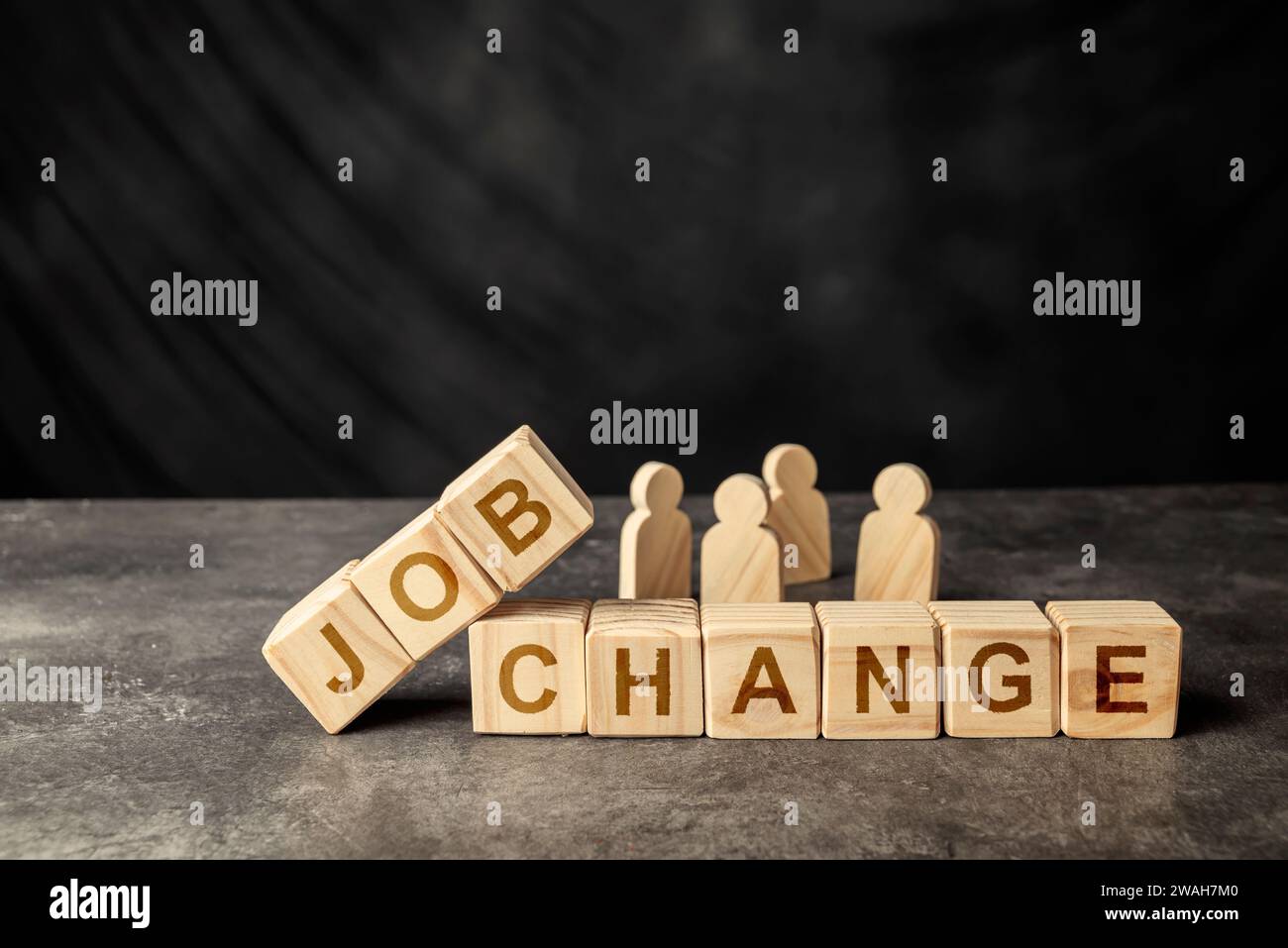 Wooden figures and cube with JOB CHANGE letter. Career growth concept ...