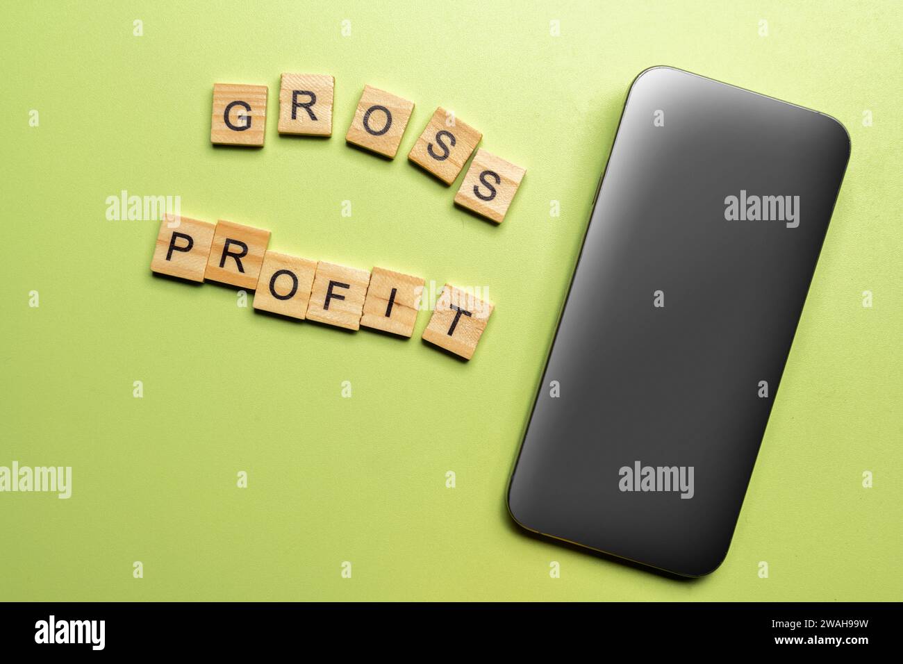 Closeup view of a mobile phone with a blank screen and a wooden cube ...