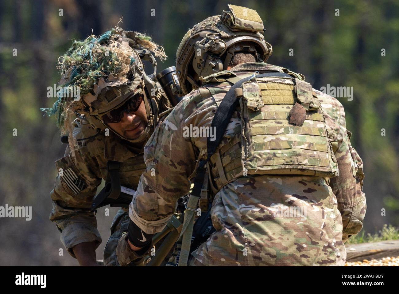 U.S. Army Soldiers aim and fire a handheld and bipod-stabilized 60mm ...