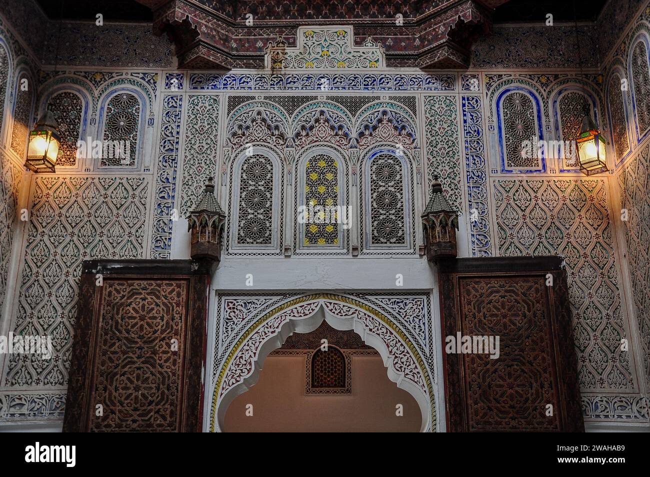Intricate coloured stucco and carved wooden doors in the patio of Dar ...