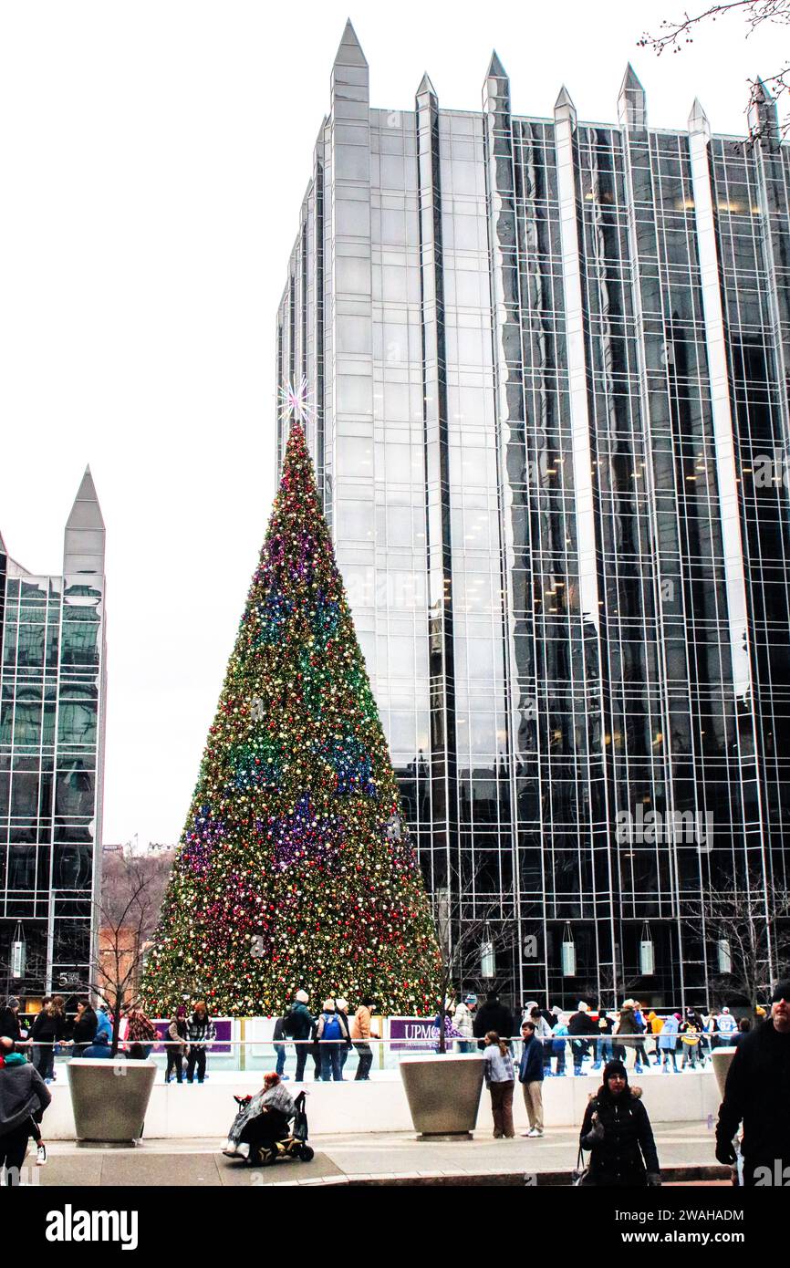 People gather along the outside of the PPG Arena Ice Rink to watch the ...