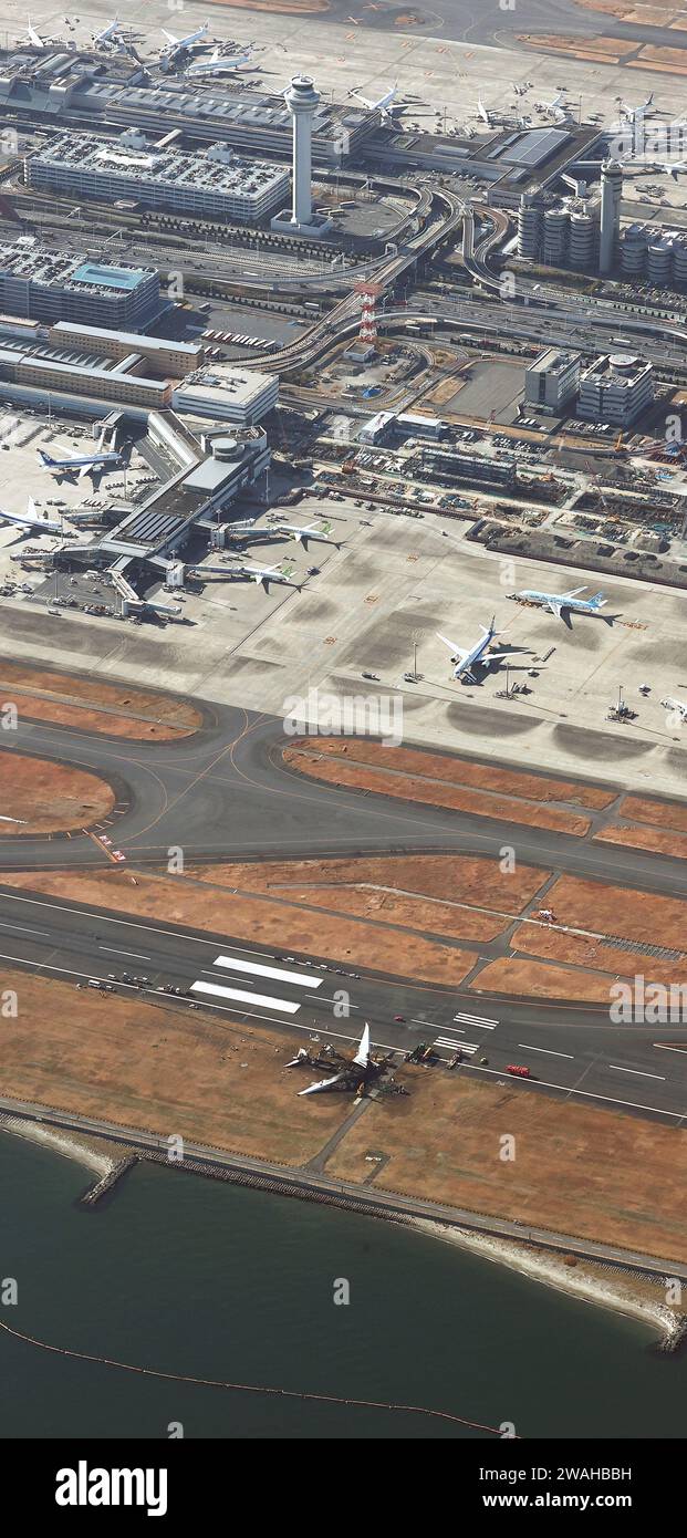 An aerial photo shows a removing work of a burnt Japan Airlines Flight ...