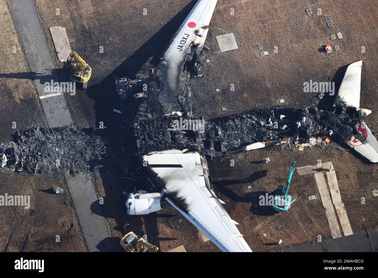 An aerial photo shows a removing work of a burnt Japan Airlines Flight ...