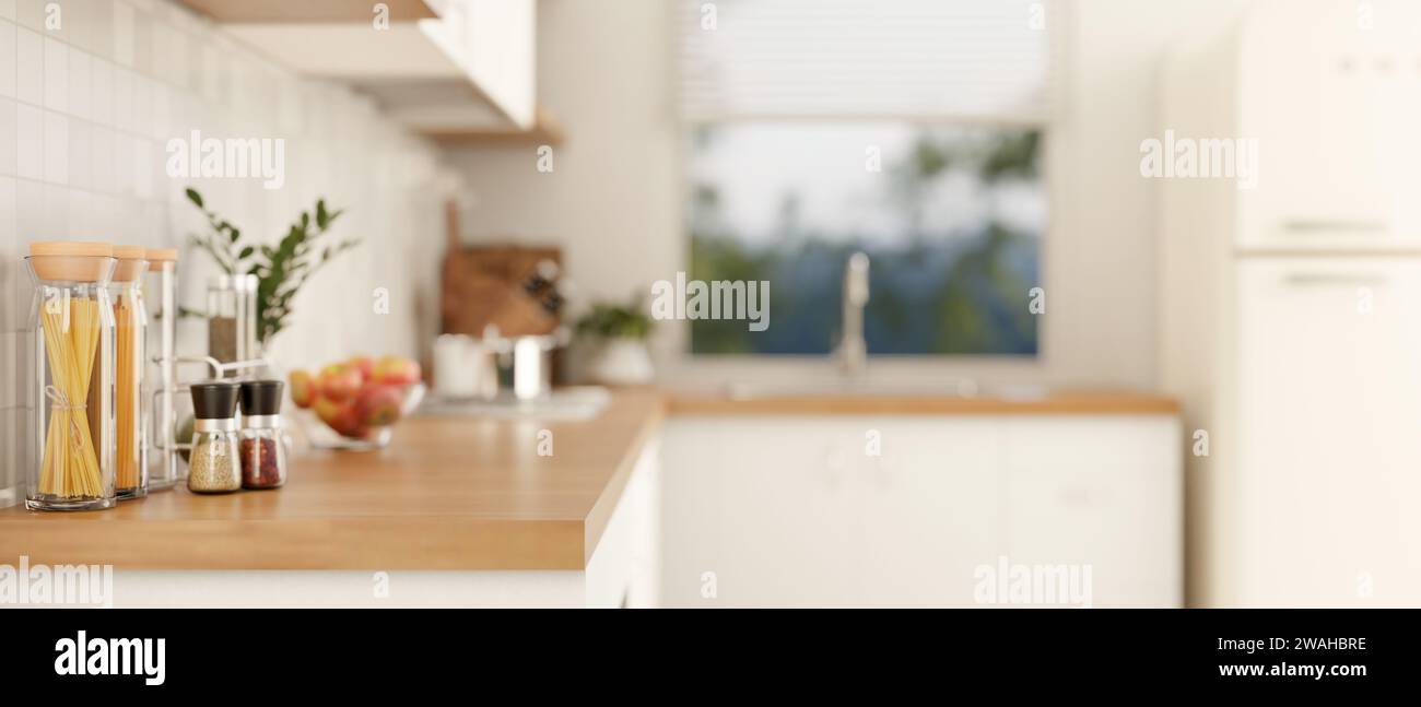 Side view of a wooden kitchen countertop with spice bottles, pasta ...
