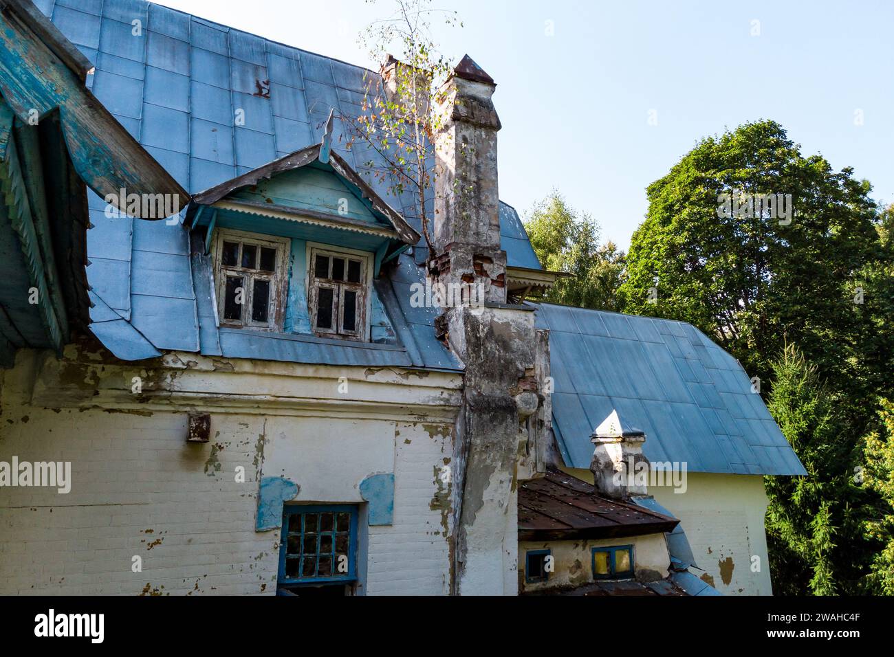 View of the attic of an old unusual house with a dormer window and a ...
