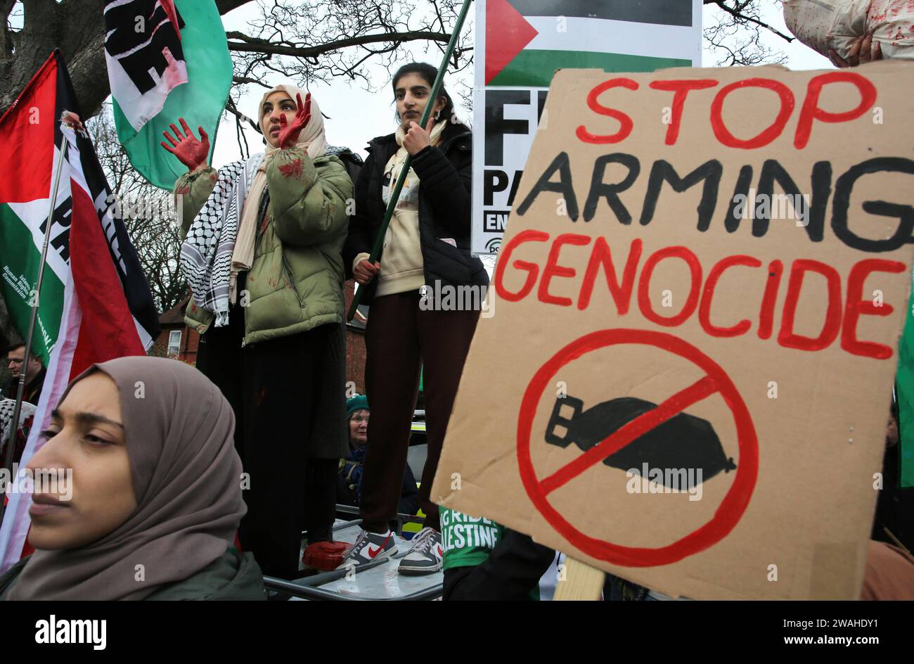 Shenstone, UK. 04th Jan, 2024. Protesters hold placards and flags ...