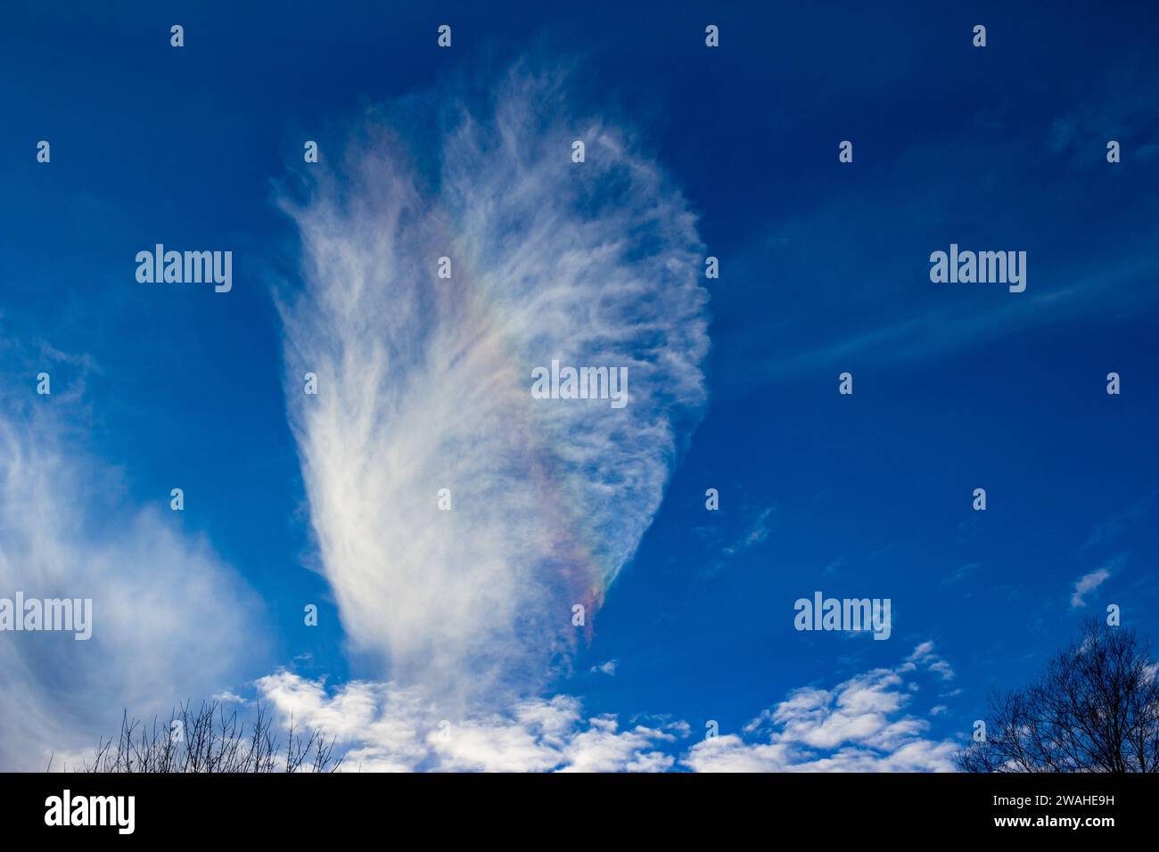 Stratus cloud with rare rainbow effect on blue sky Stock Photo - Alamy