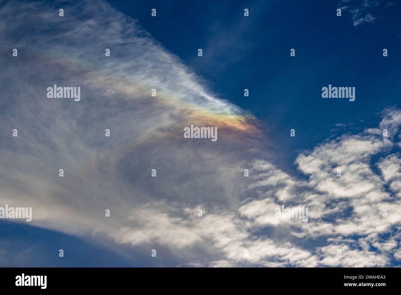 Stratus cloud with rare rainbow effect on blue sky Stock Photo - Alamy