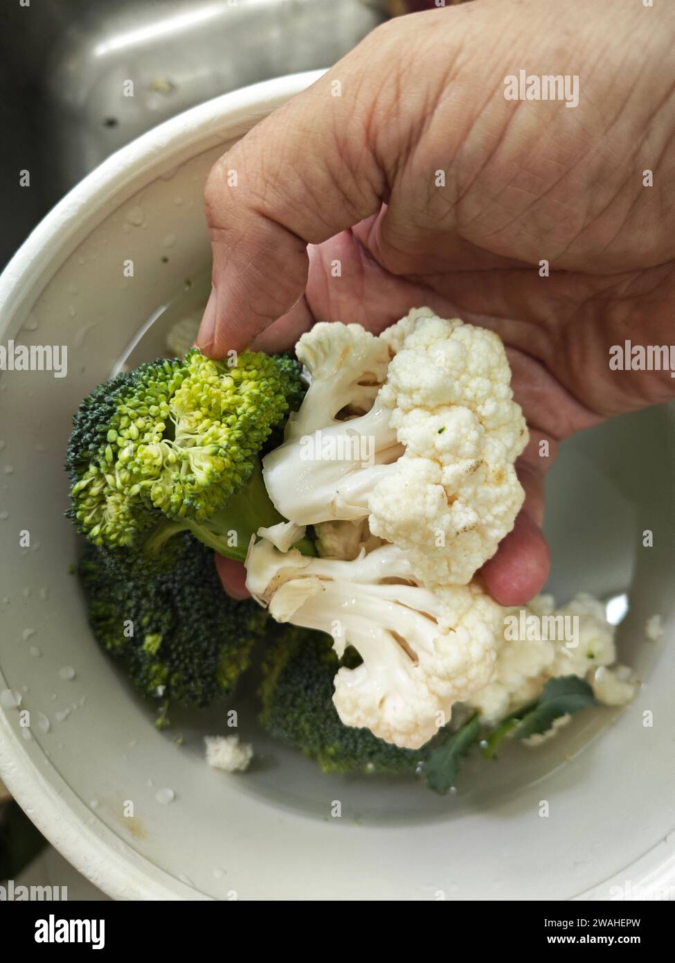 soaking small chucks of white and green cauliflower in the container ...