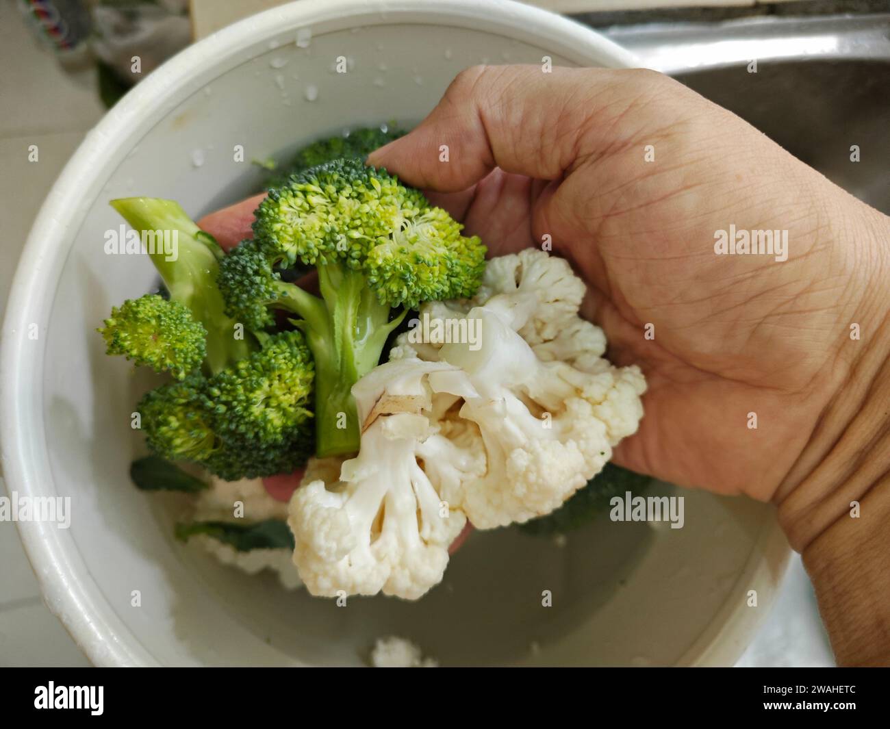 soaking small chucks of white and green cauliflower in the container ...