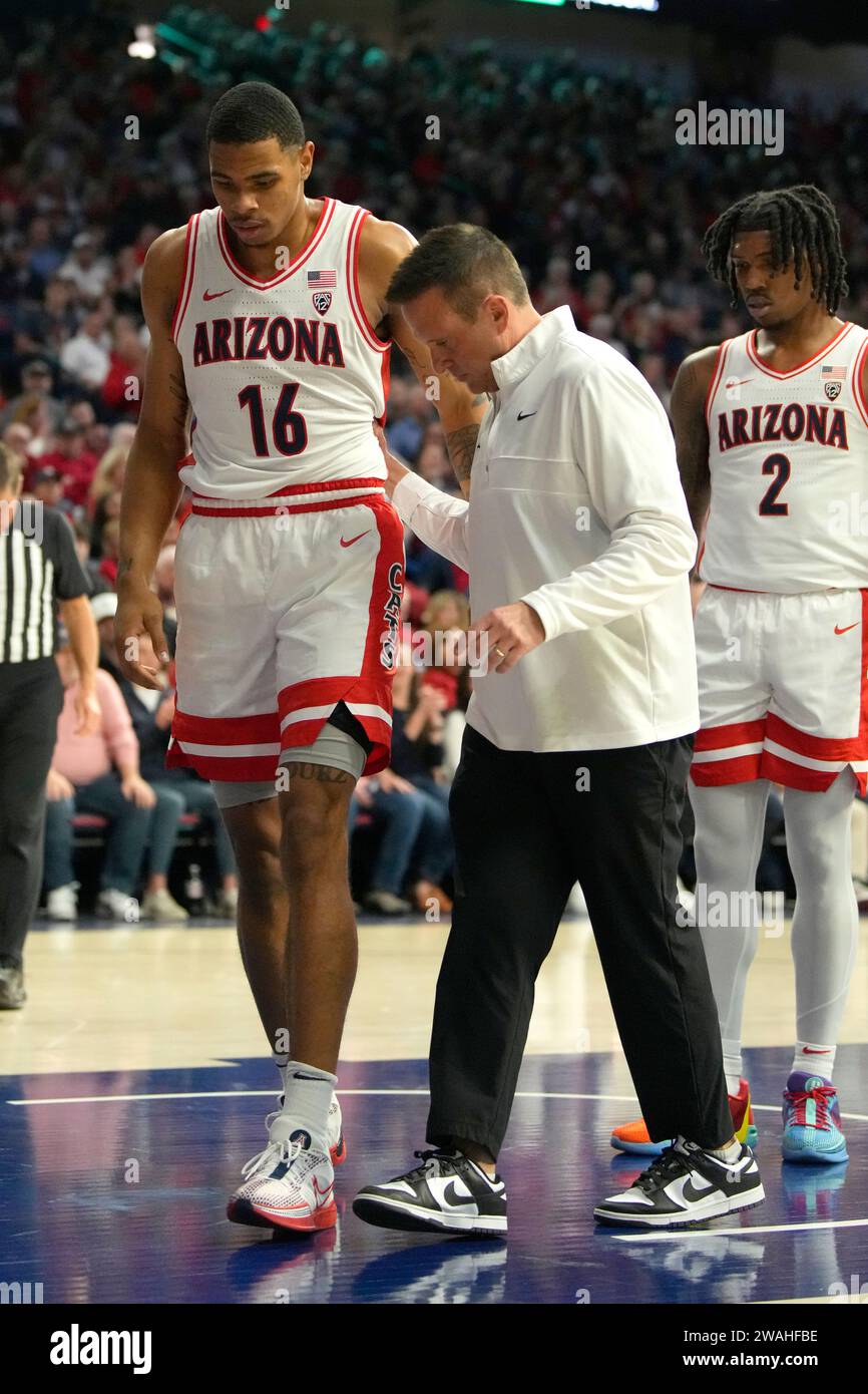 Arizona forward Keshad Johnson (16) gets helped off the court by the ...