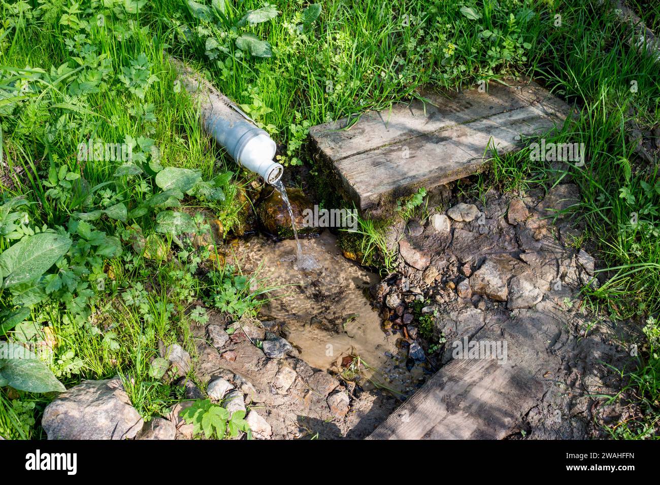 Spring with clean water equipped with a plastic pipe Stock Photo - Alamy