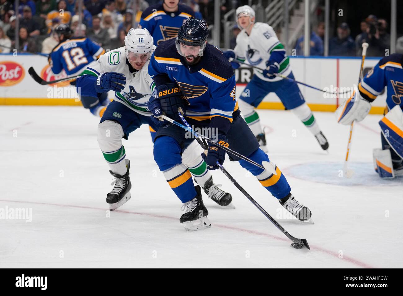 St. Louis Blues' Nick Leddy (4) controls the puck as Vancouver Canucks ...