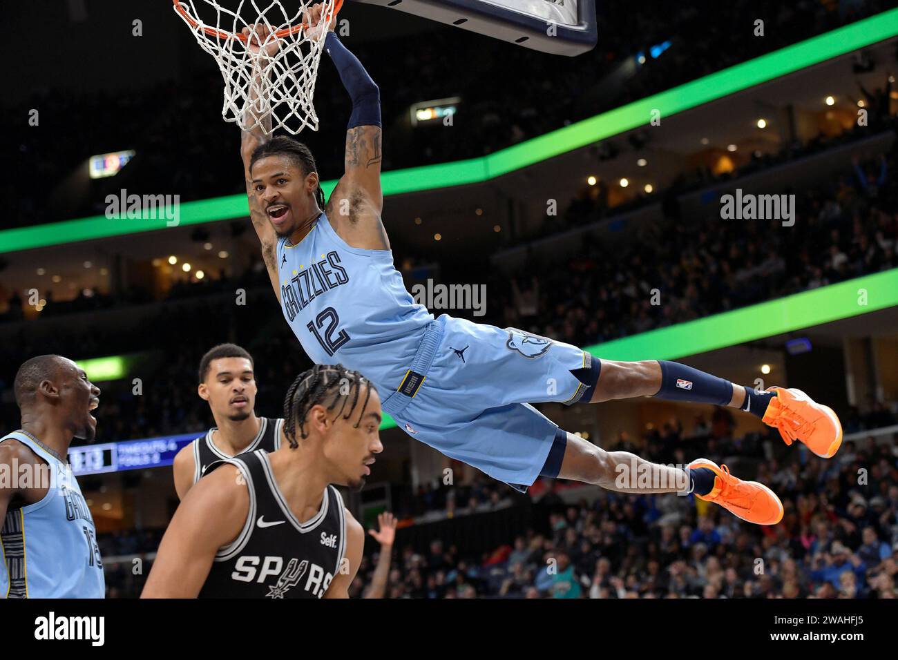 Memphis Grizzlies guard Ja Morant (12) hangs from the rim after dunking ...