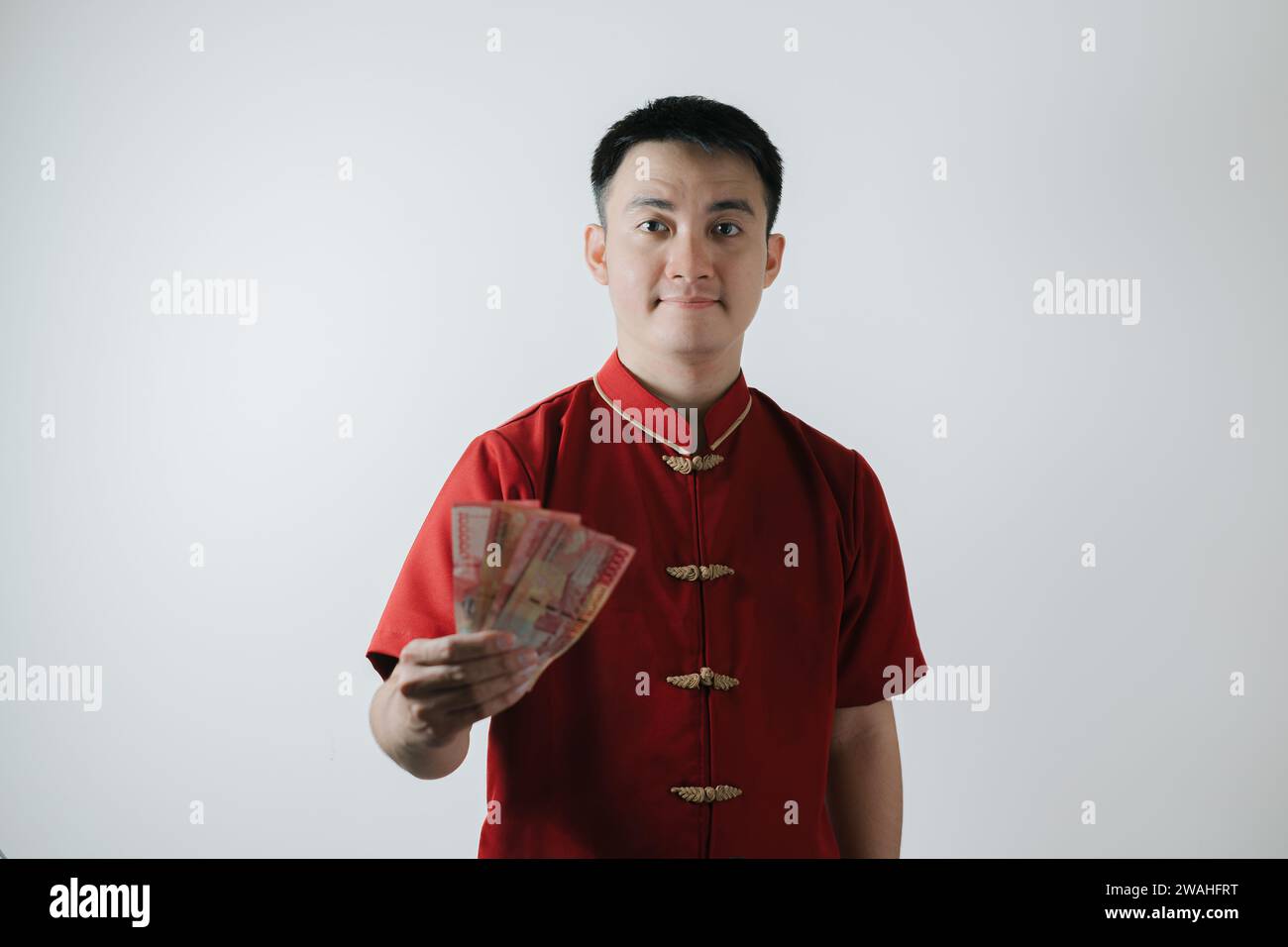 Asian man wearing Cheongsam or Chinese traditional cloth is holding ...