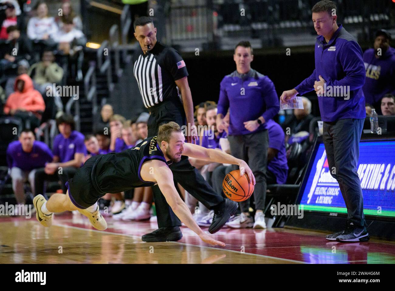 James Madison guard Noah Freidel, front left, stretches to try and keep ...