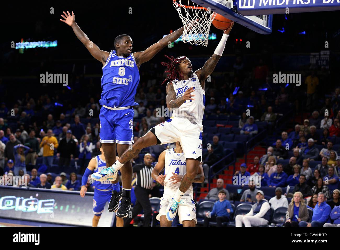 Tulsa guard Cobe Williams (24) shoots a layup past Memphis forward ...